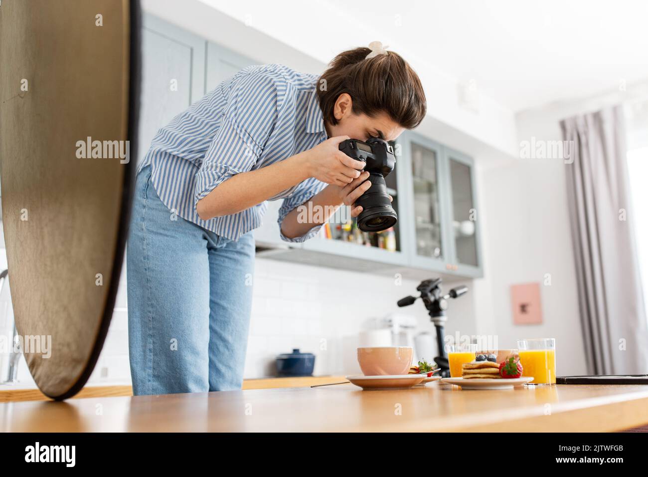 food photographer with camera working in kitchen Stock Photo - Alamy