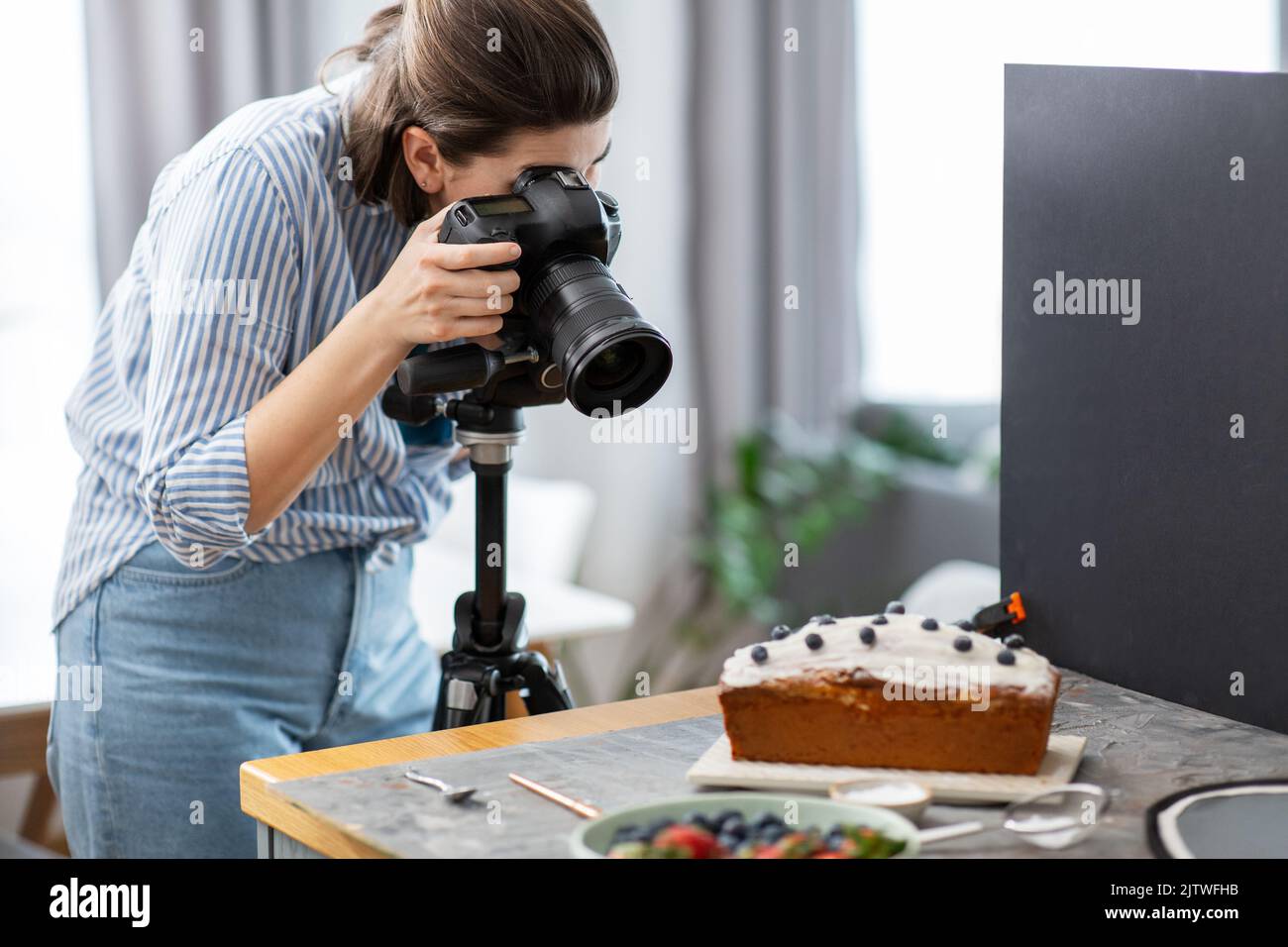 food photographer with camera working in kitchen Stock Photo - Alamy