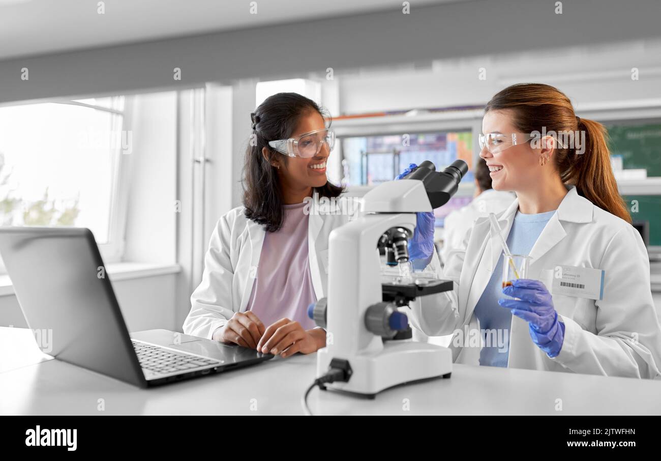 scientists with microscopes working in laboratory Stock Photo - Alamy