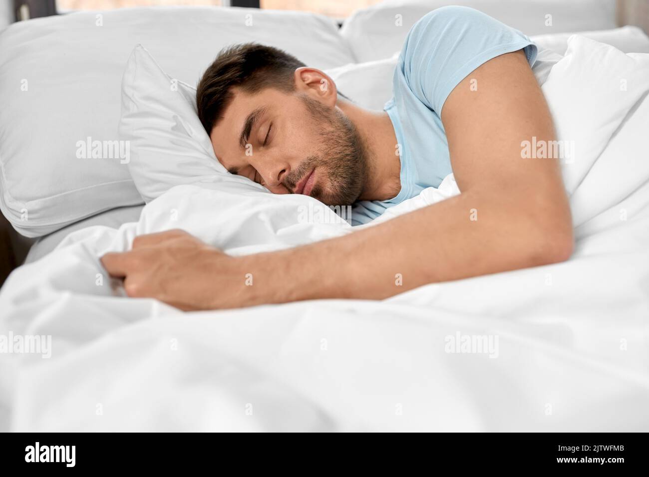 man sleeping in bed at home Stock Photo - Alamy