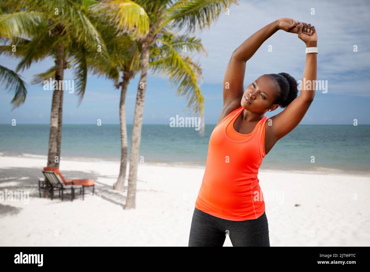Woman stretching on tropical beach hi-res stock photography and images ...