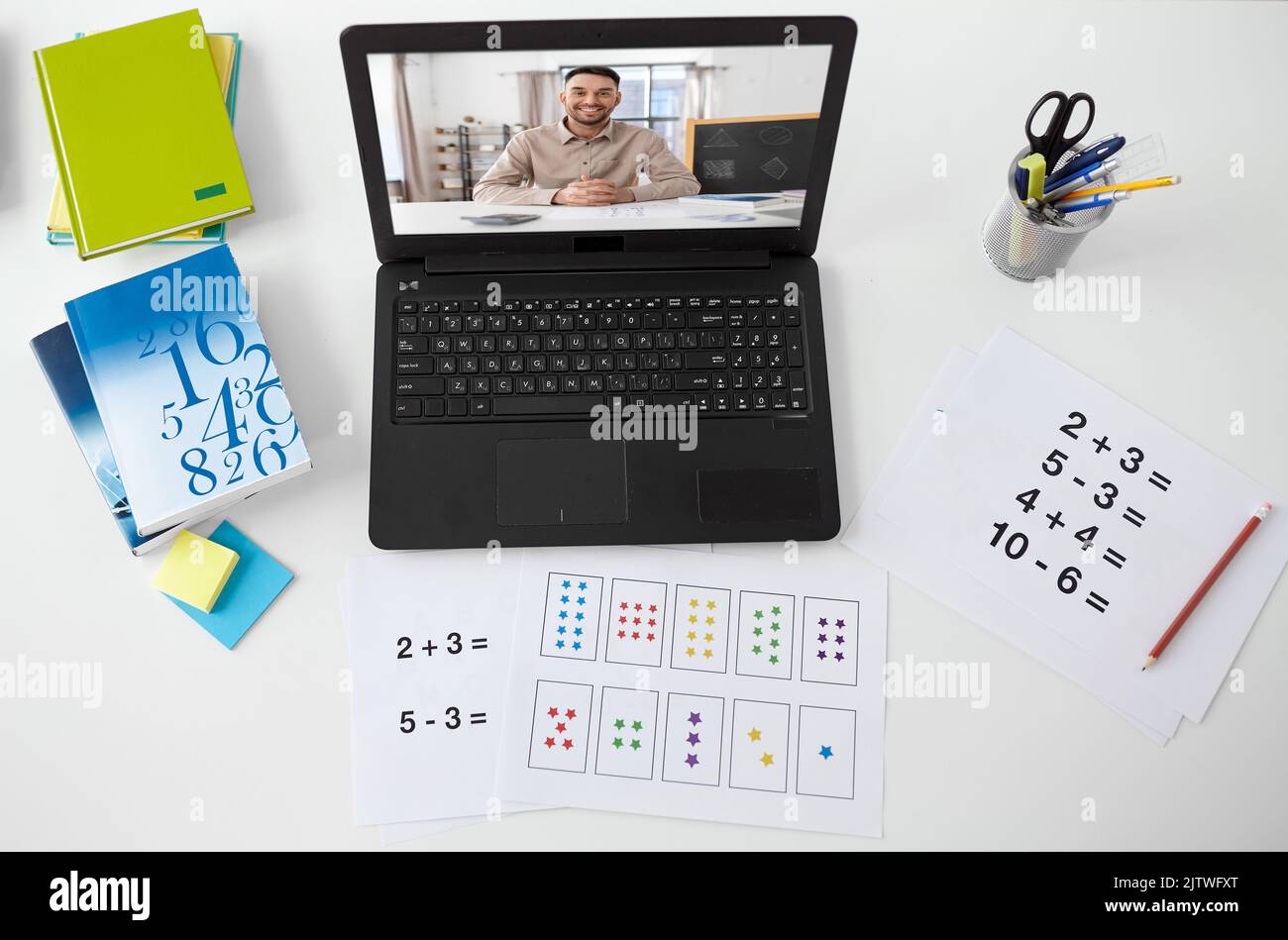 primary school teacher on laptop screen on table Stock Photo - Alamy