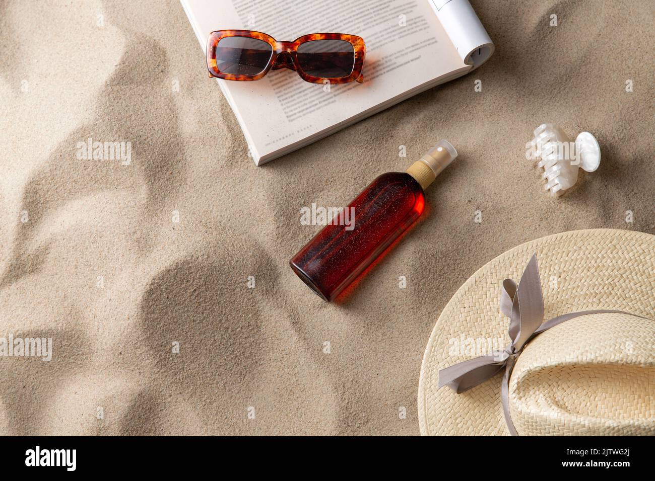 magazine, sunglasses and sunscreen on beach sand Stock Photo - Alamy