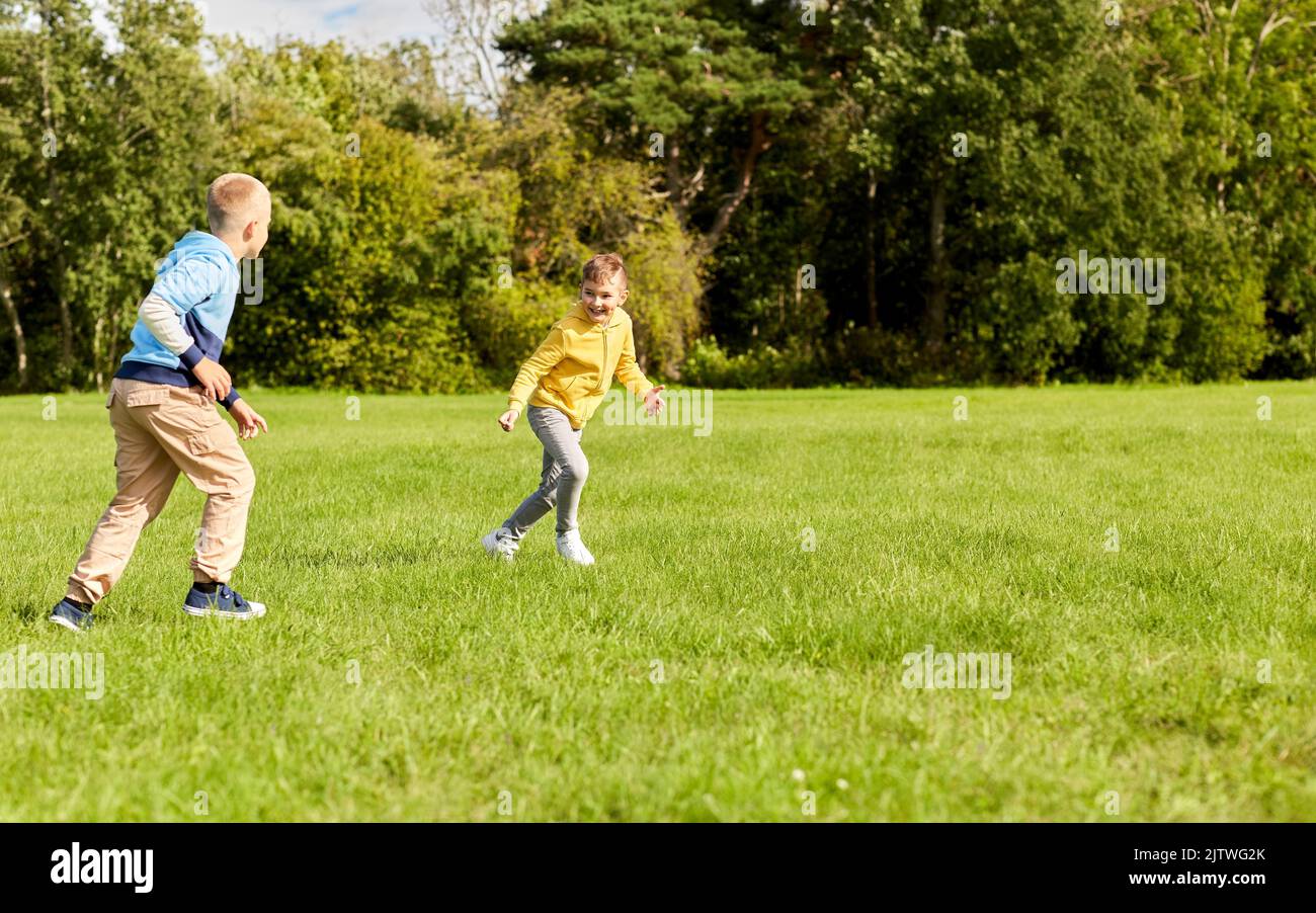 two happy boys playing tag game at park Stock Photo - Alamy