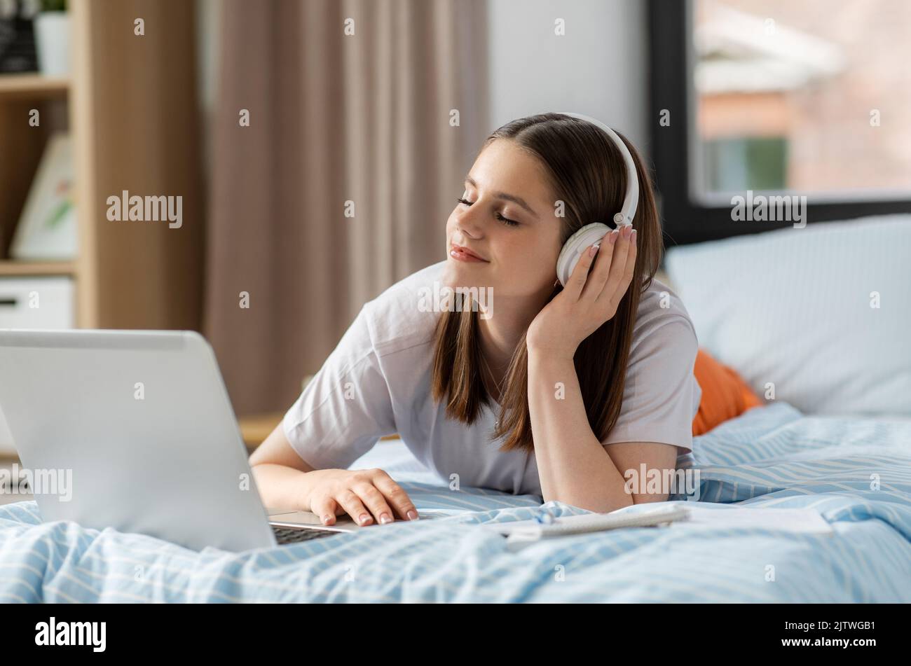 happy student girl in headphones learning at home Stock Photo - Alamy