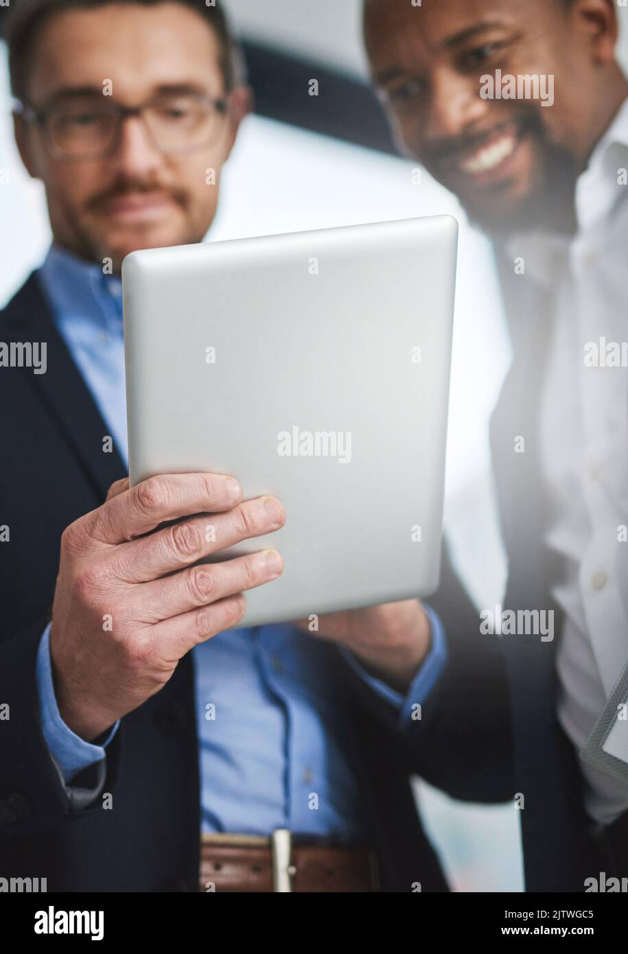 Who needs a business card when youve got a tablet. two businessmen ...