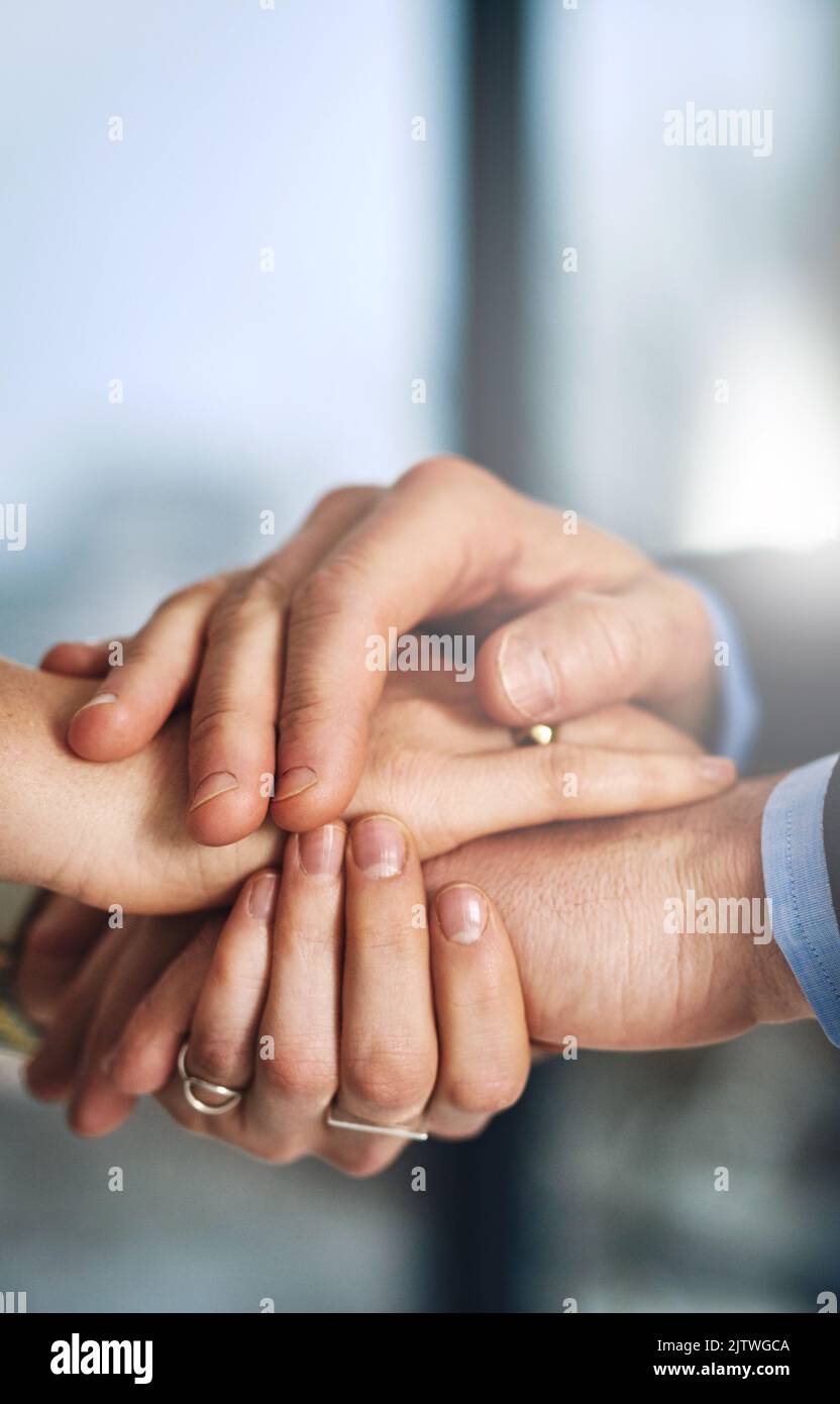 Kindness creates kindness. two colleagues holding hands Stock Photo - Alamy