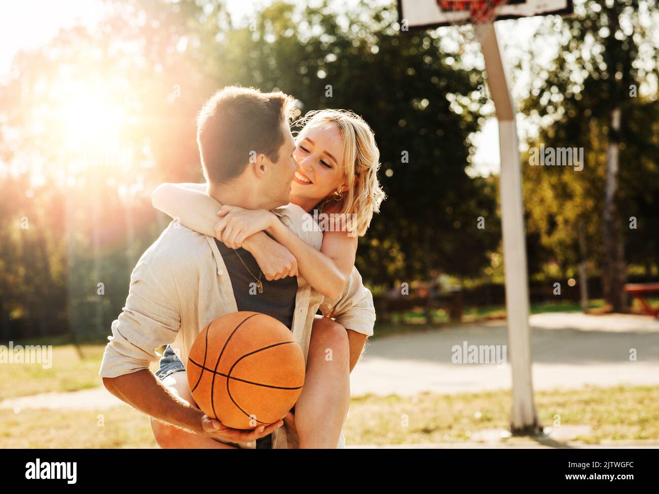 happy couple having fun on basketball playground Stock Photo - Alamy