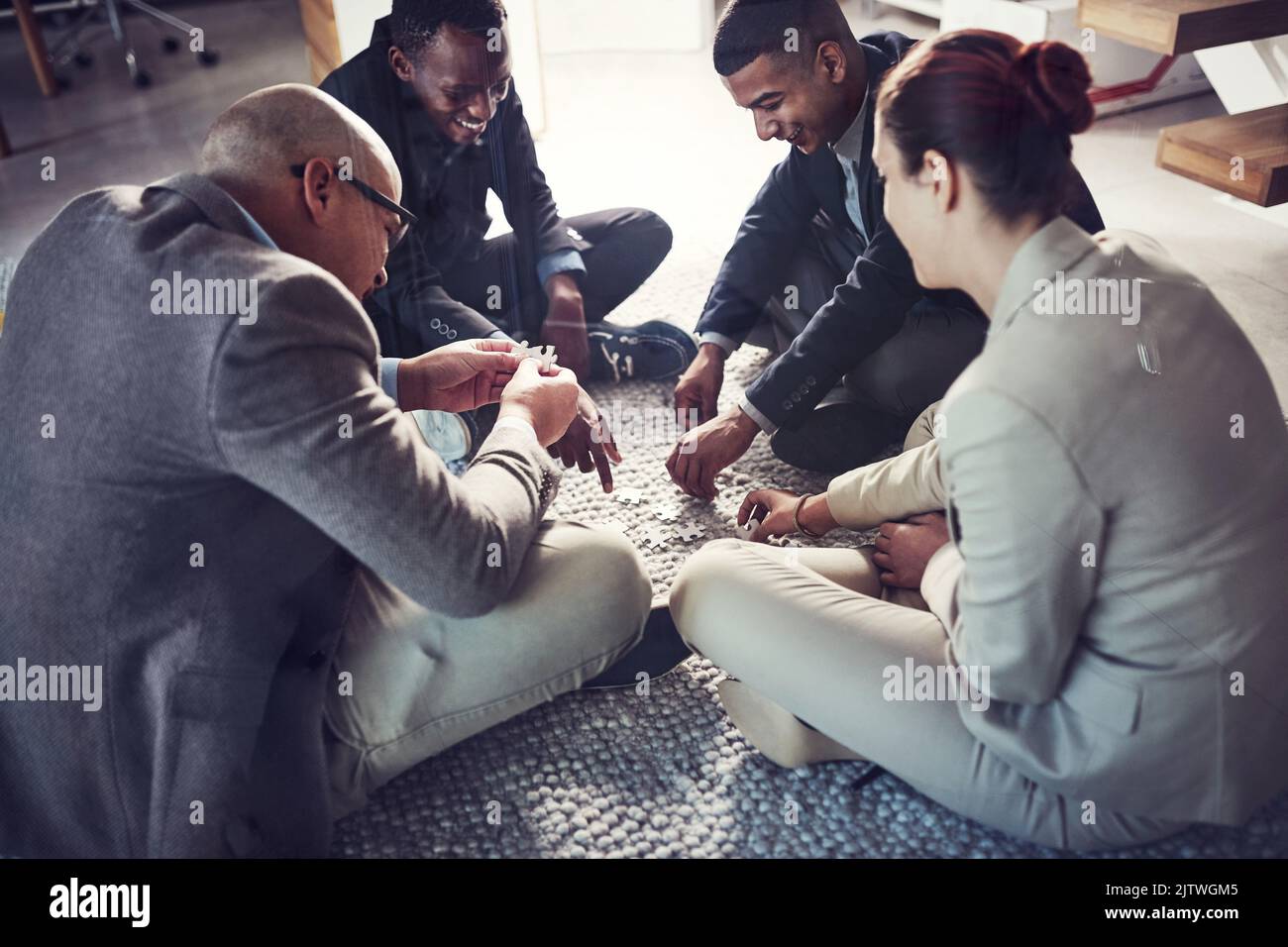 Things are slowly coming together. a group of coworkers putting a ...