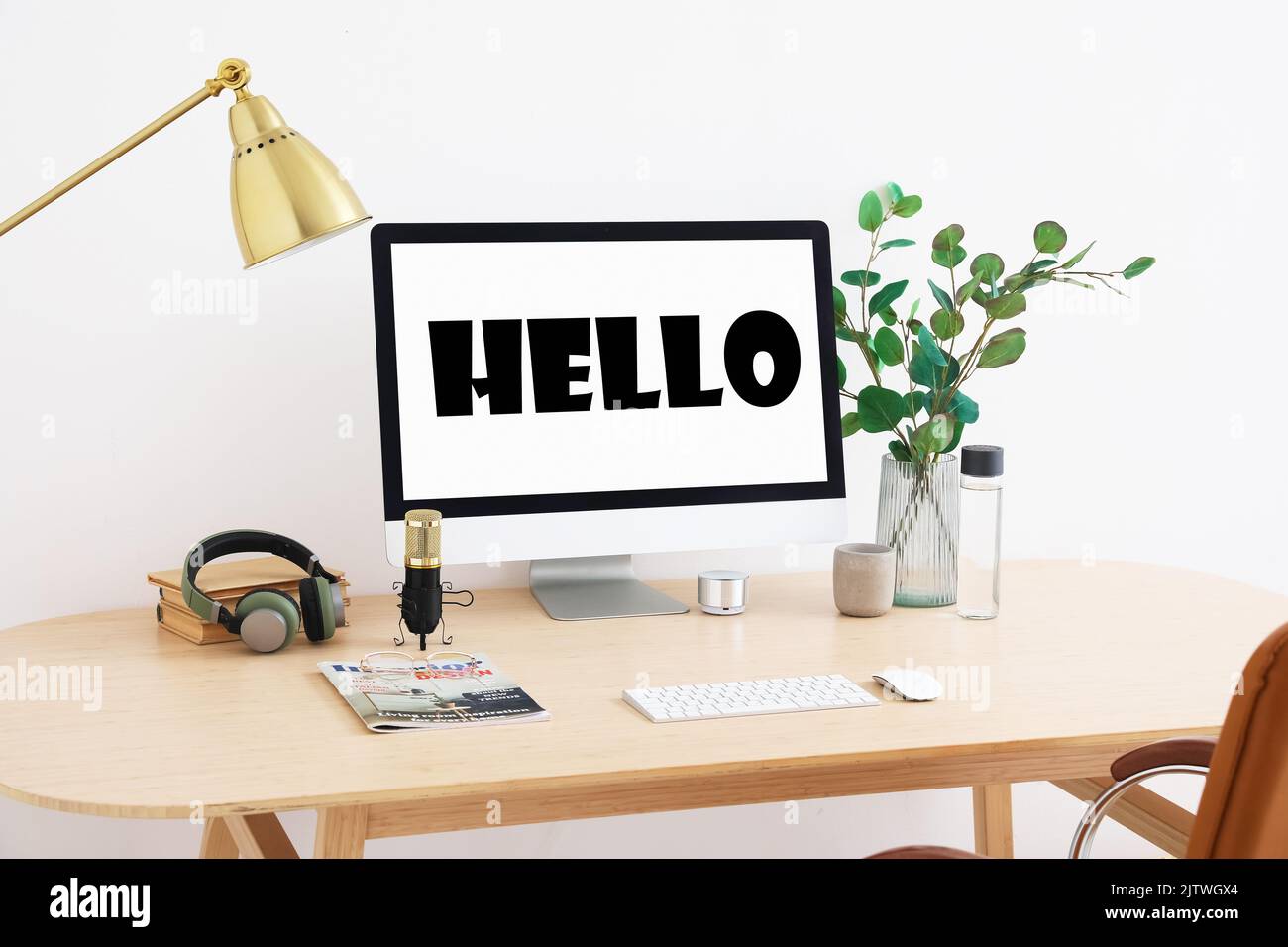 Modern computer with word HELLO on screen in room Stock Photo - Alamy