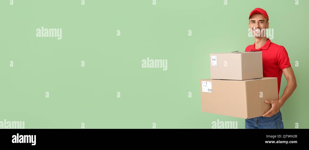 Delivery man with parcels on green background with space for text Stock ...