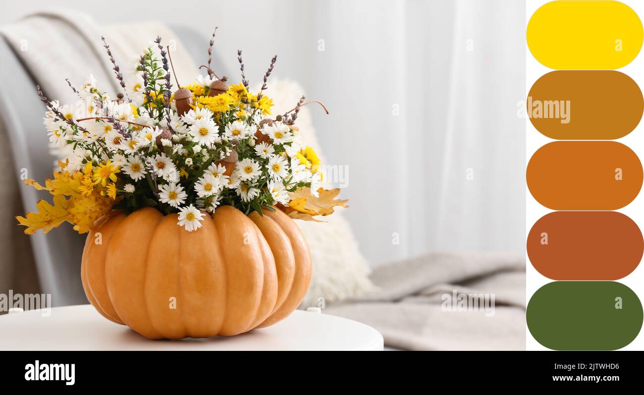 Beautiful autumn bouquet in pumpkin on table in room. Different color ...