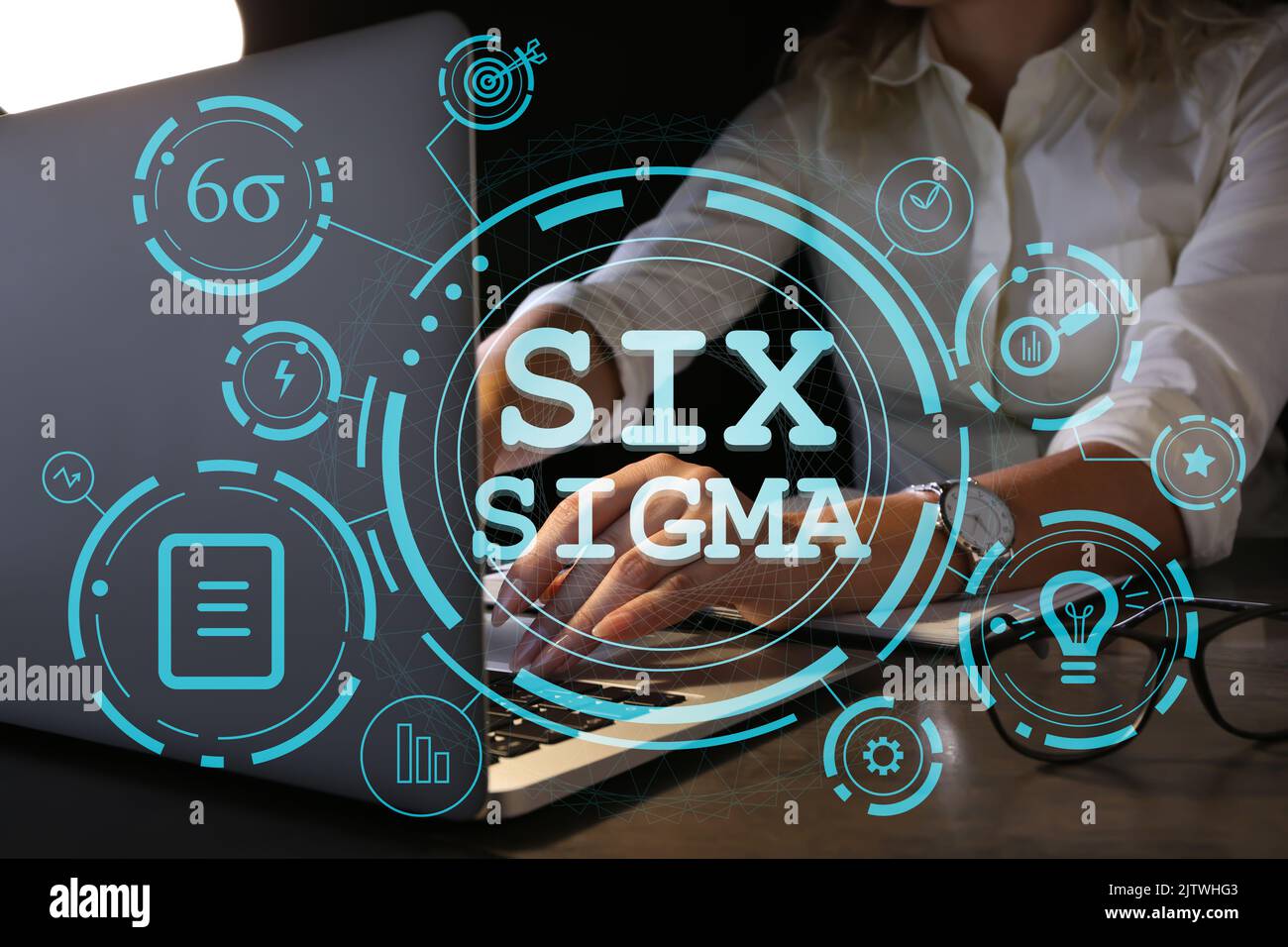 Woman with laptop in office. 6 sigma concept Stock Photo - Alamy