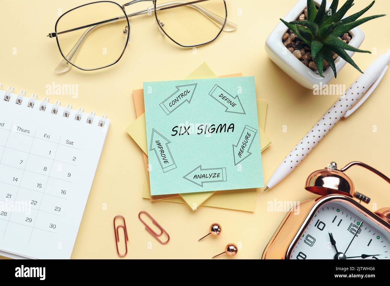 Note papers with text SIX SIGMA and stationery on light background ...