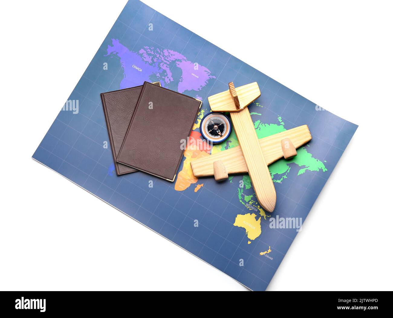 World map, passports, wooden airplane and compass isolated on white ...