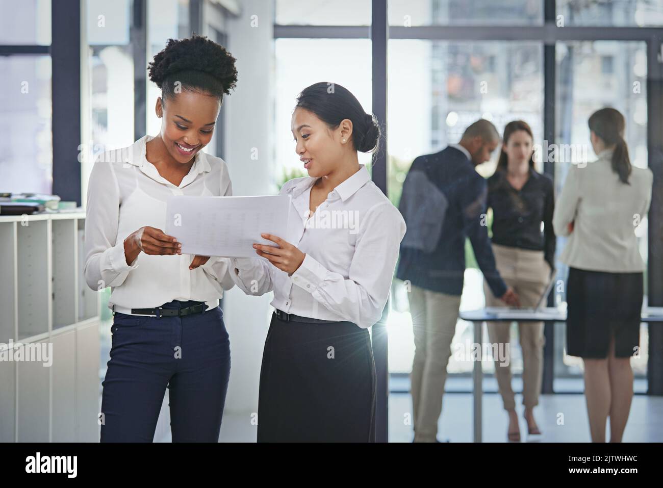 She loves to see her ideas come alive on paper. two female work ...