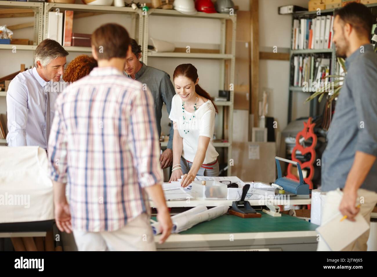 Putting their plans into place. a group of architects working together ...