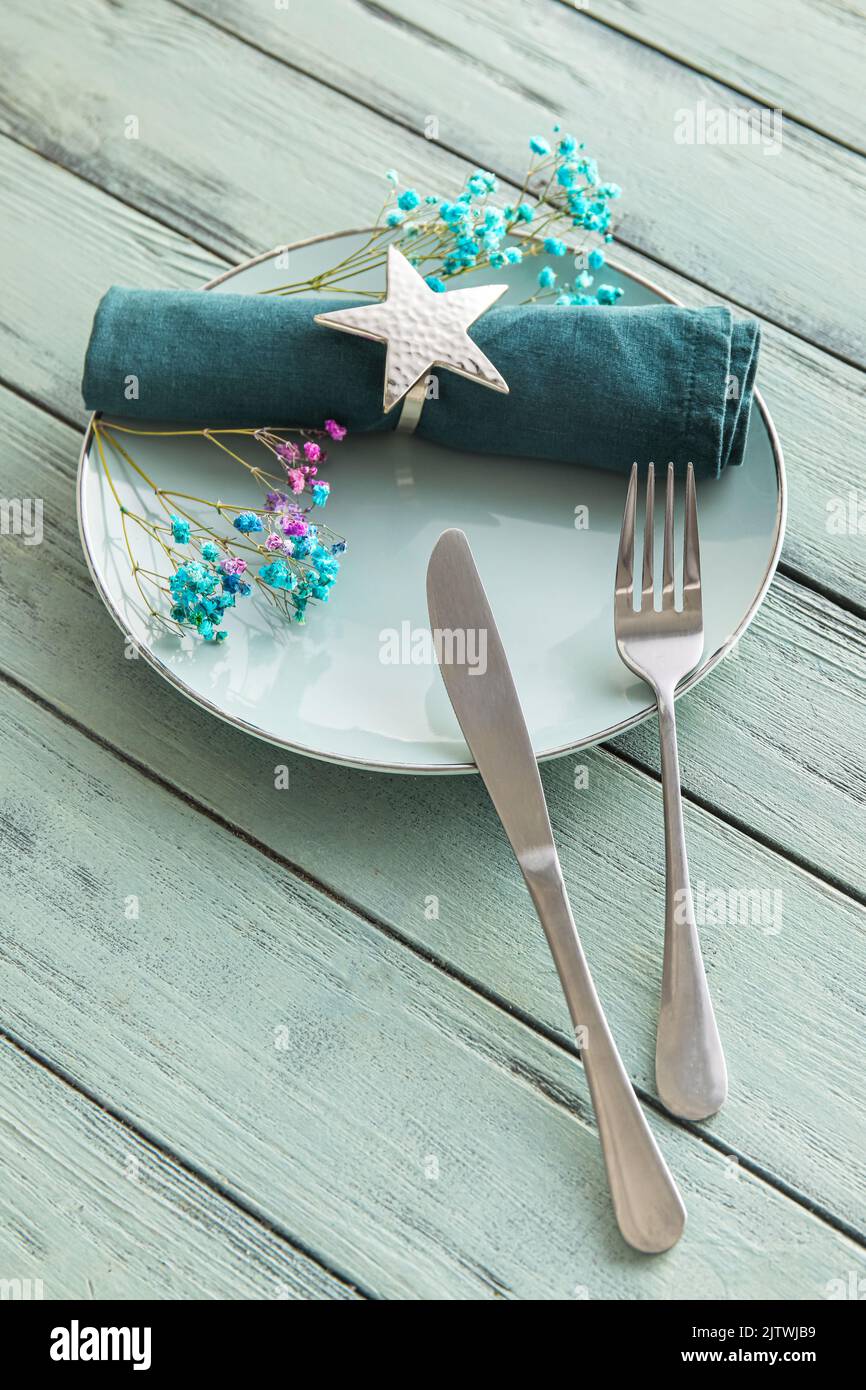 Beautiful table setting with gypsophila flowers on color wooden ...