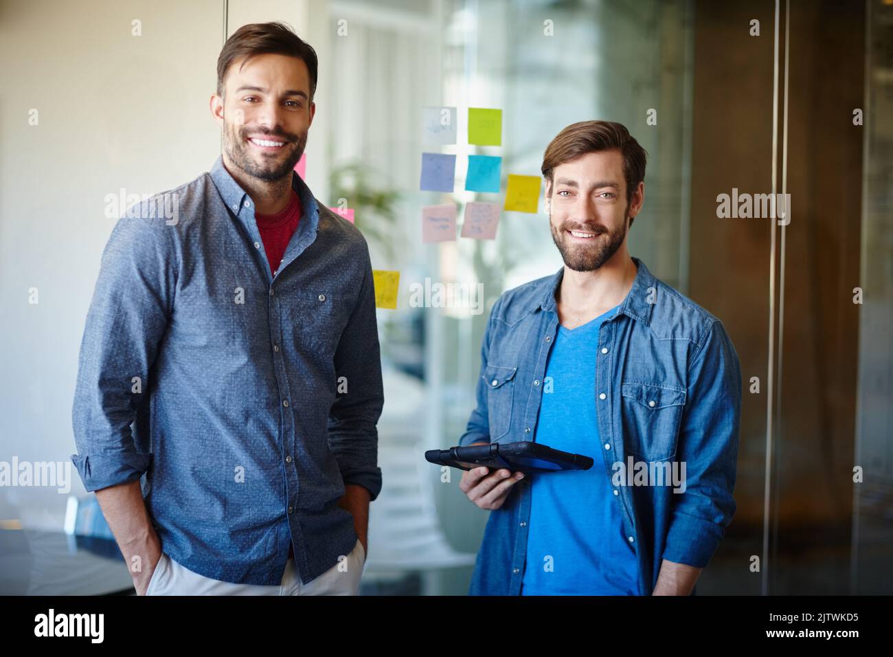 Were the face of success. Portrait of two young businessmen standing ...