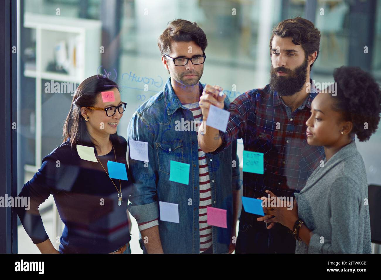 Picking up their tasks for the day. a group creative businesspeople ...