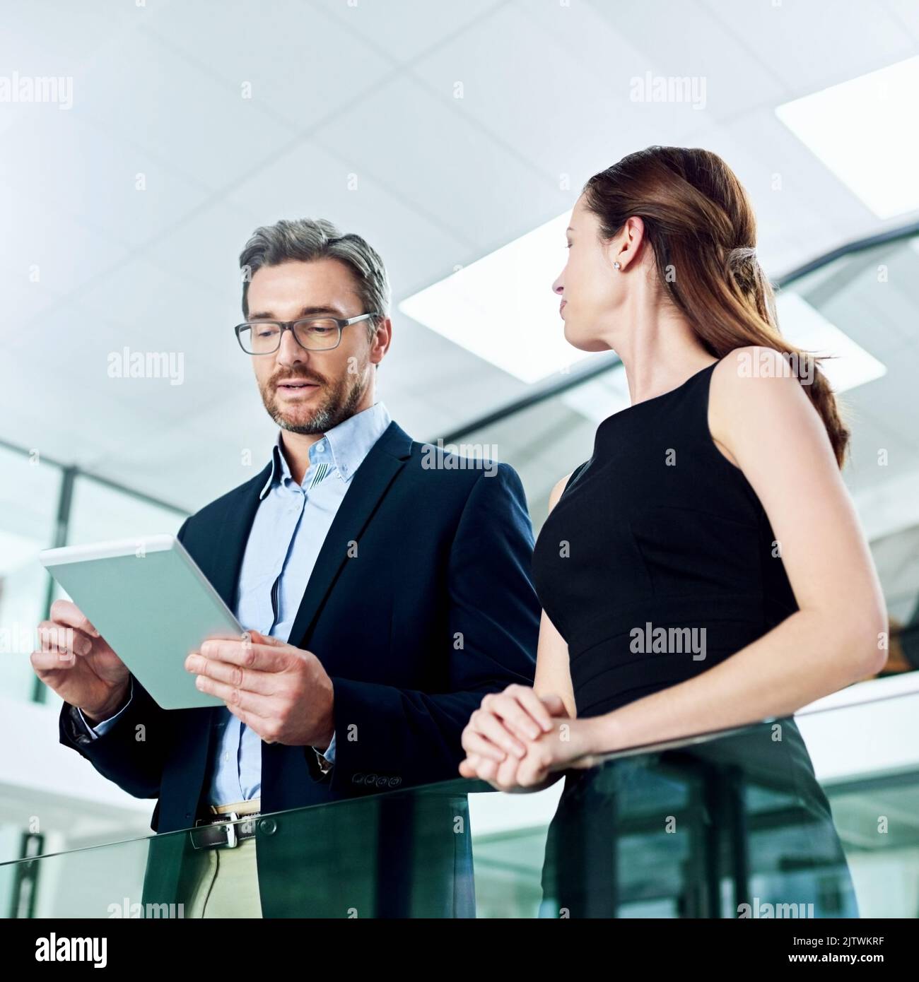 Getting some input on his latest project. Low angle shot of two ...