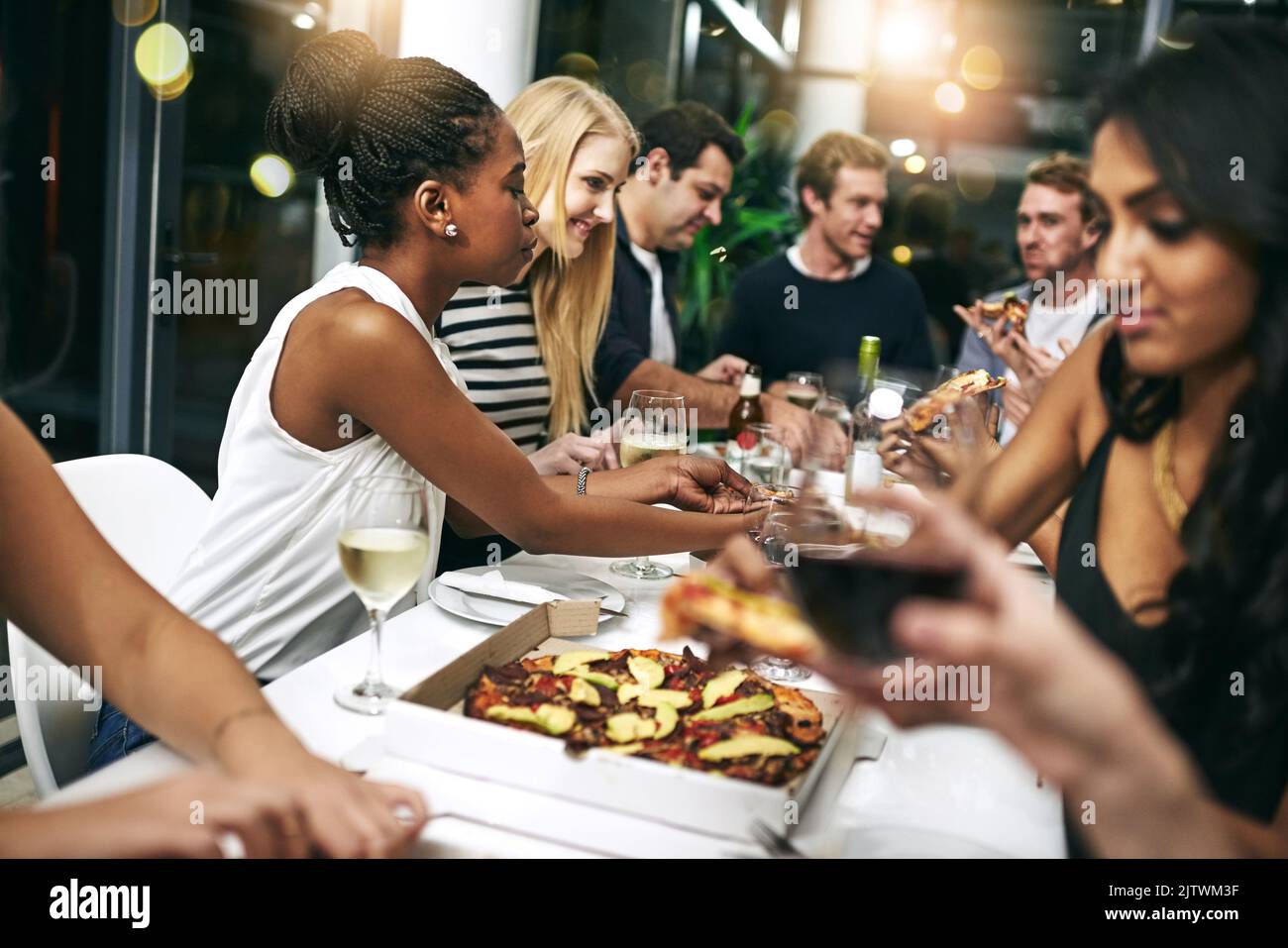 Enjoying a dinner party with friends. a group of young friends having a ...