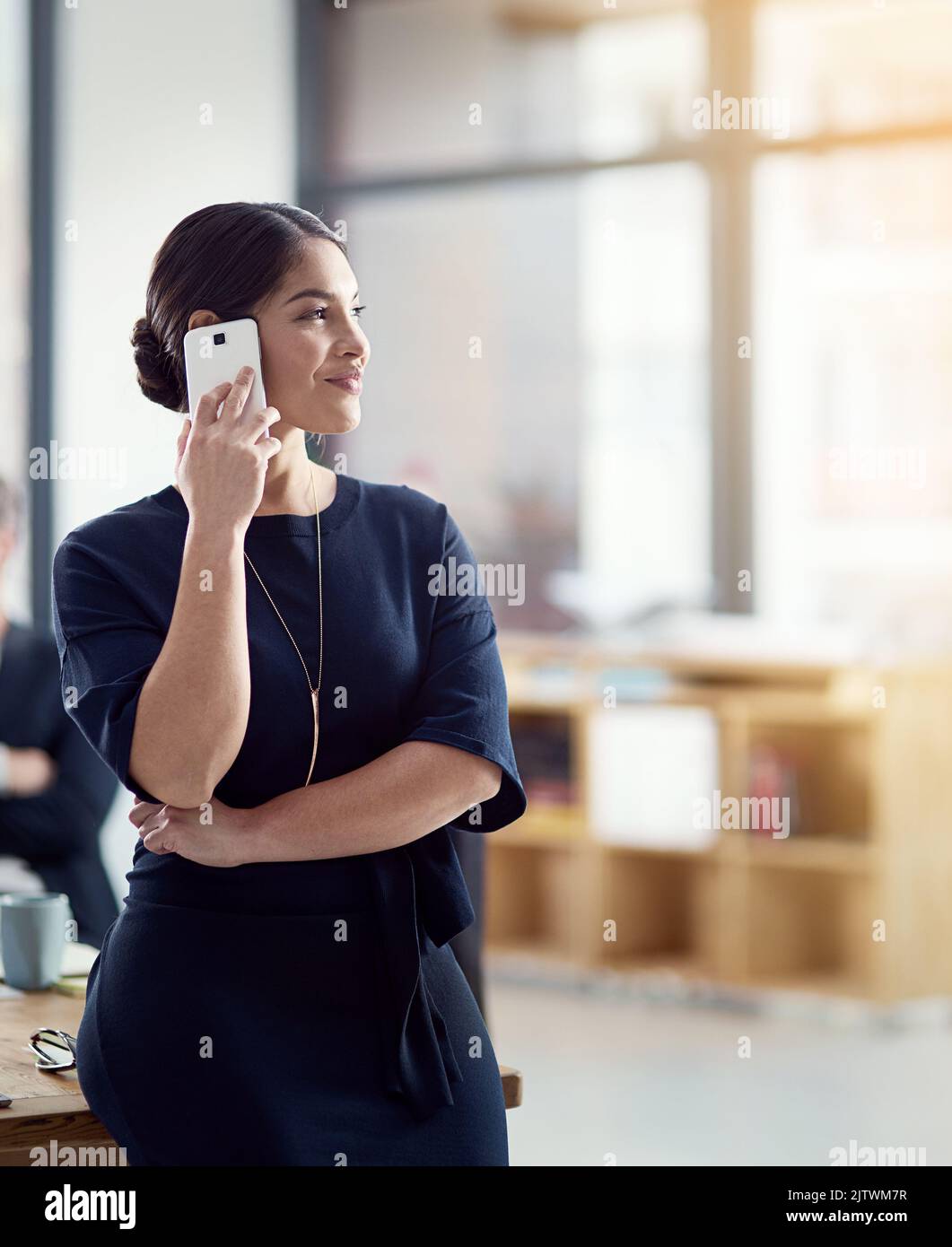 Success is calling. a young businesswoman talking on a cellphone in a ...