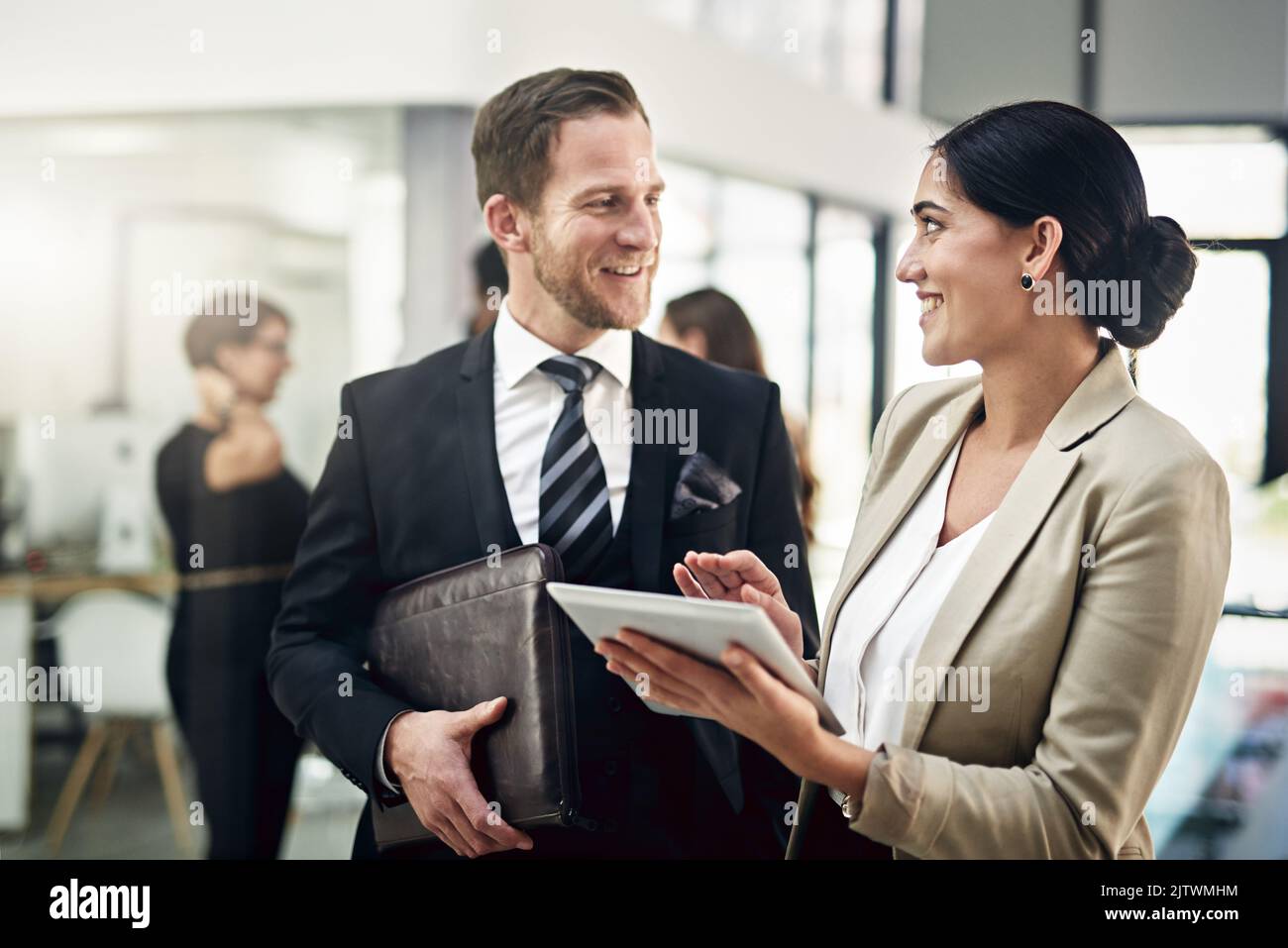 His input is invaluable. two businesspeople looking at a tablet in the ...