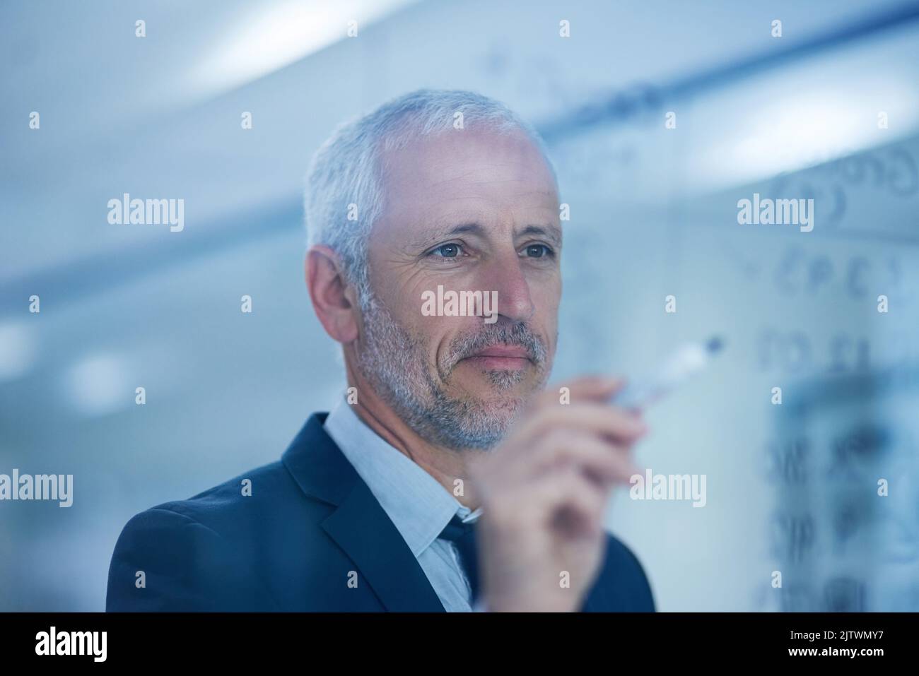 Expanding on his business potential. a mature businessman writing ...