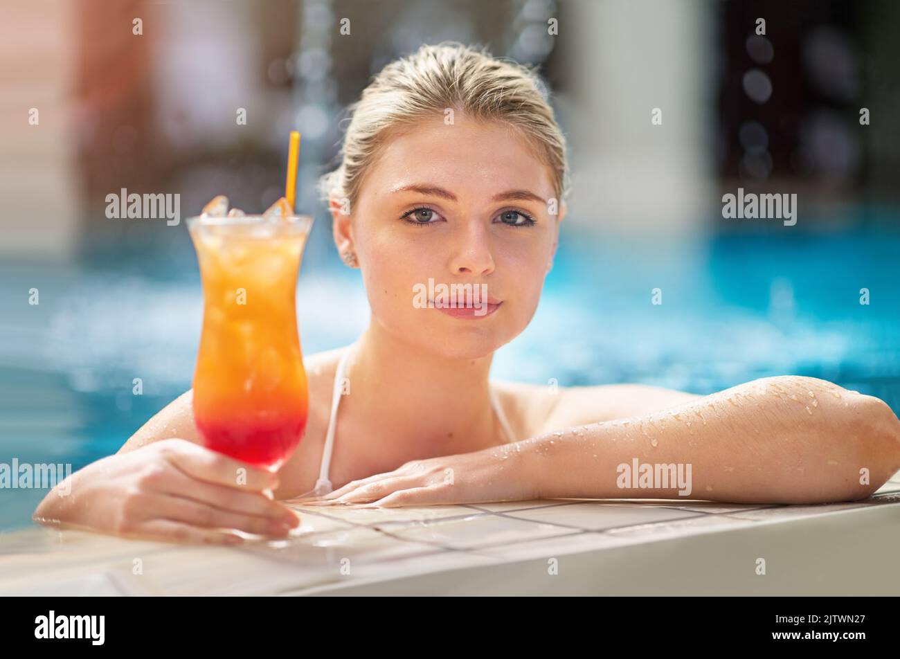 Let the relaxation begin. Portrait of a young woman drinking a cocktail ...