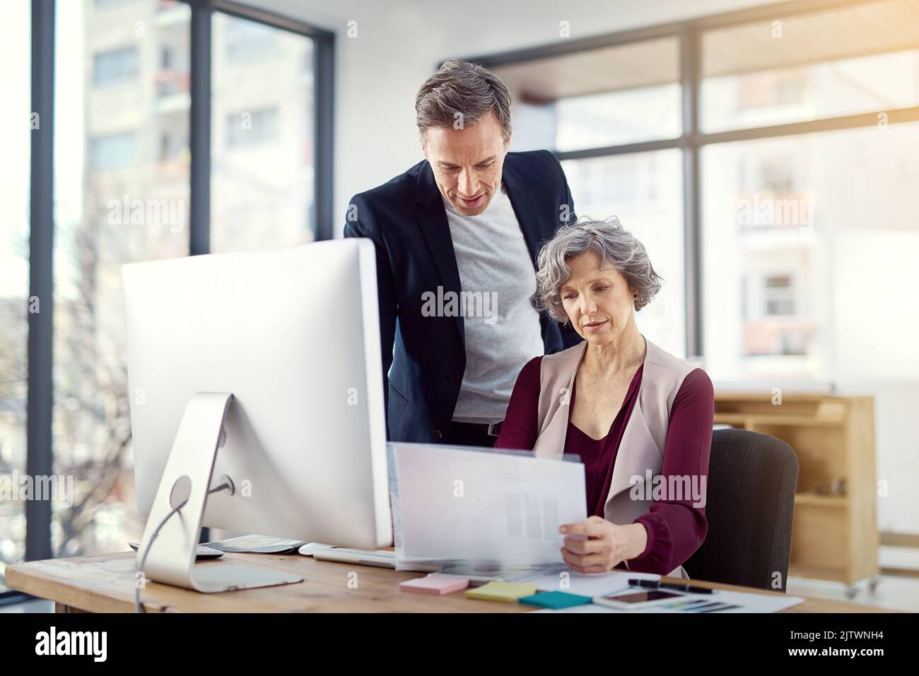 Our chances of success are bigger together. two businesspeople working ...