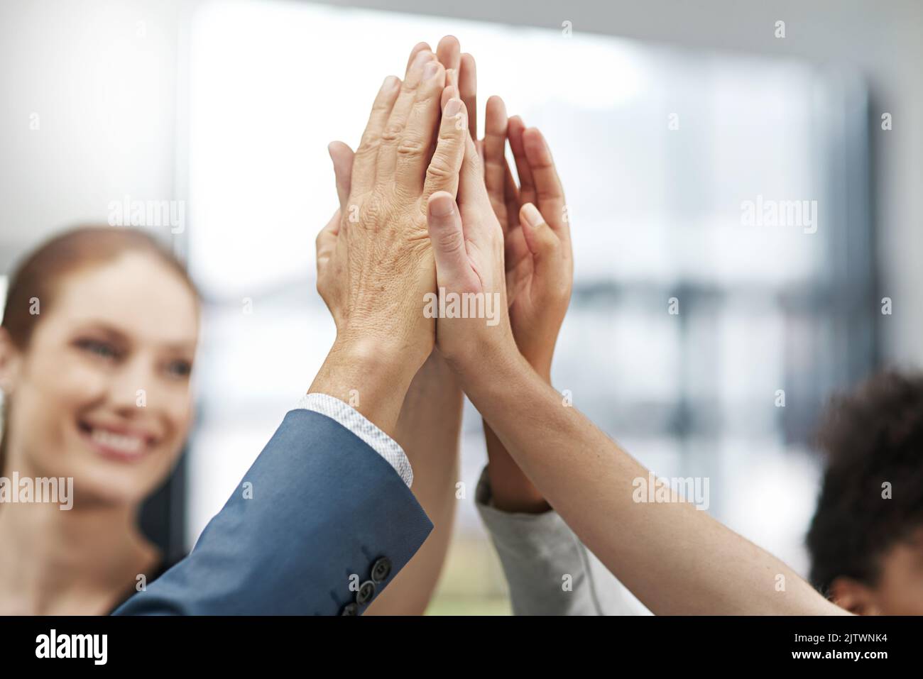 Weve reached our target. Closeup shot of a group of businesspeople high ...