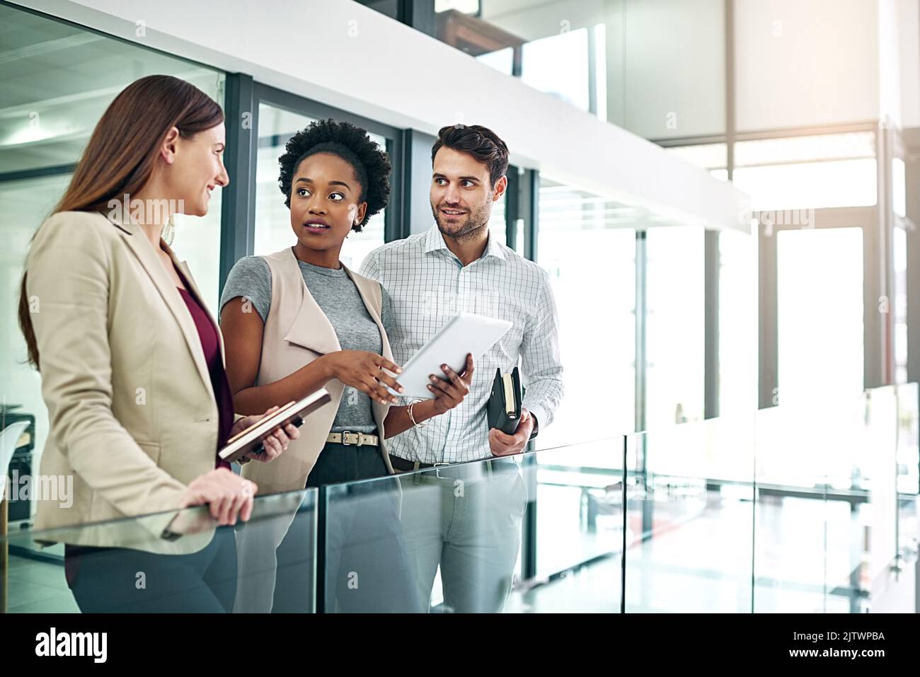 Running their report by the boss. a group of colleagues talking ...