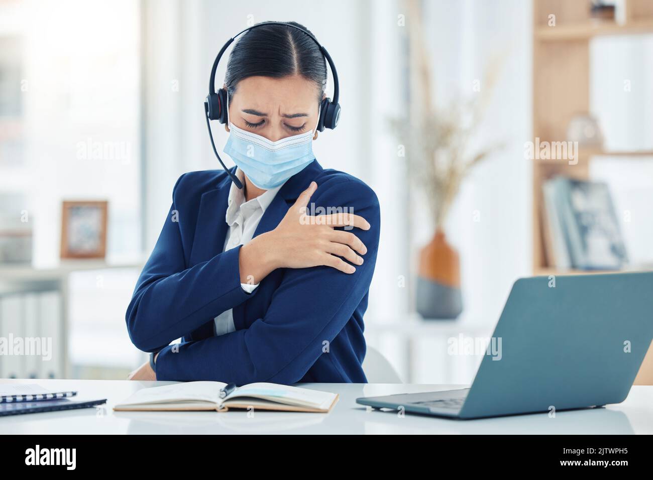 Call center, shoulder injury and woman at the office in pain holding ...