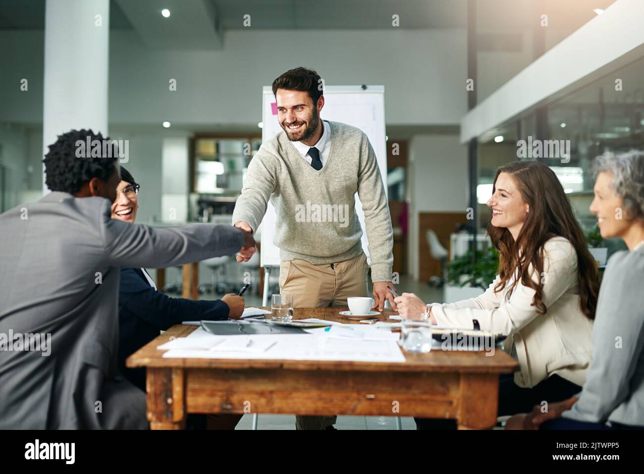 Welcome to the team. two businessmen shaking hands during a meeting ...