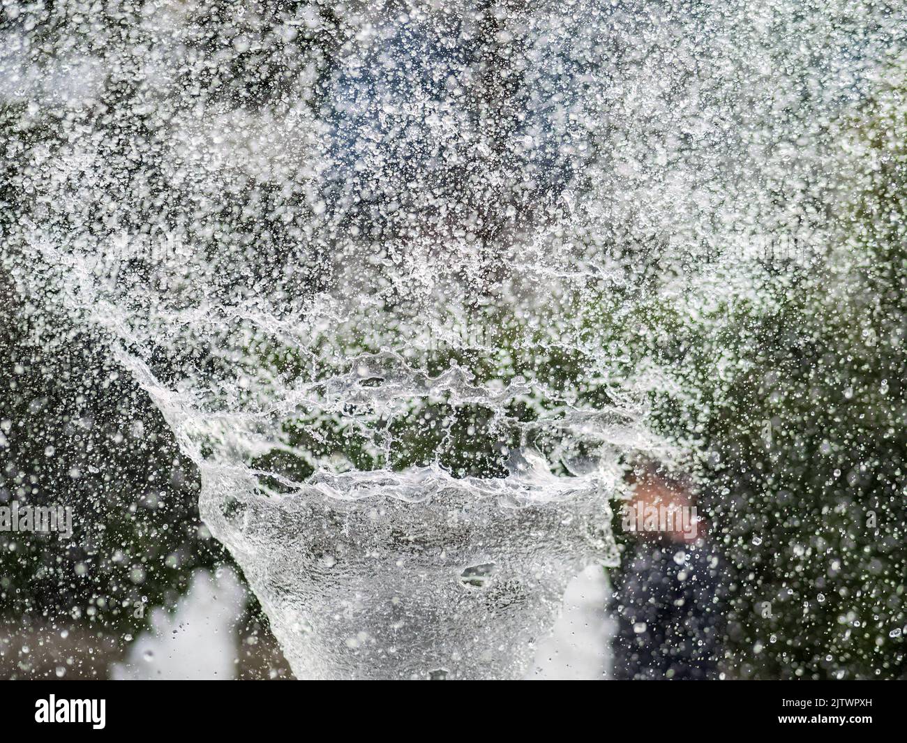 Water splashes from fountain on dark background. Natural texture of ...