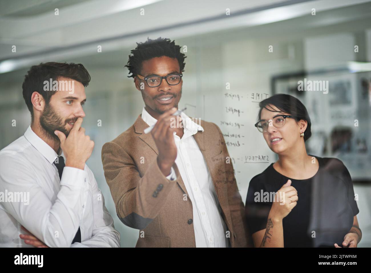 Innovative solutions in the making. a diverse group of businesspeople ...