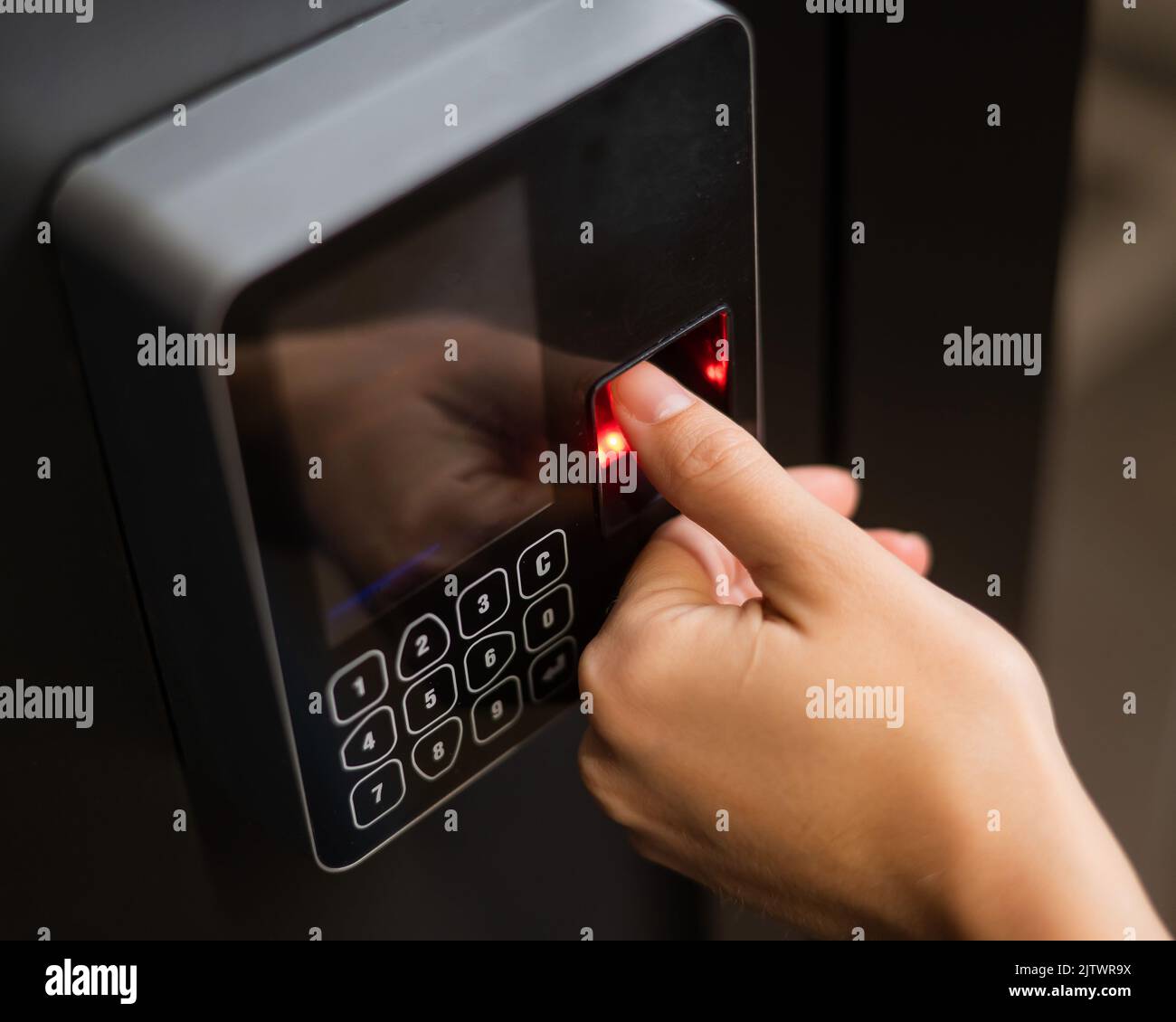 A woman opens the door with her fingerprint. Modern keyless entry lock ...