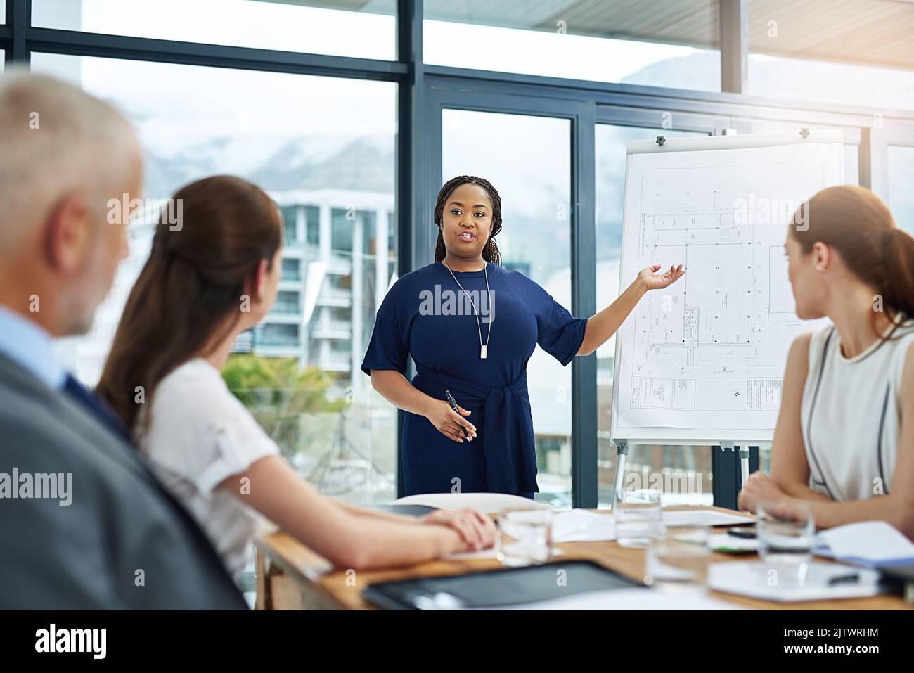 Presenting with poise. a young businesswoman giving a presentation in ...