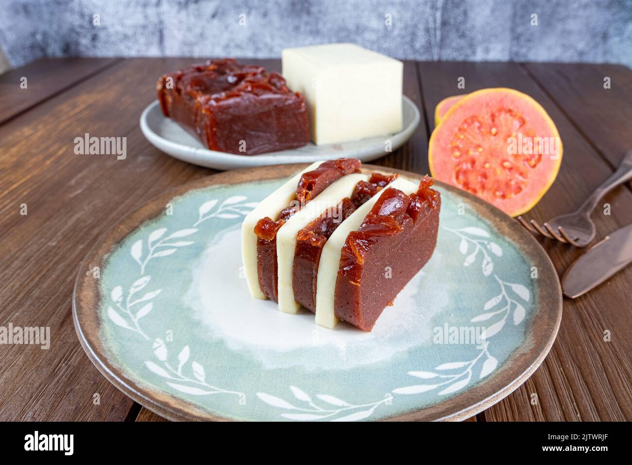 Slices of guava sweet and curd cheese. In the blurred background, guava ...
