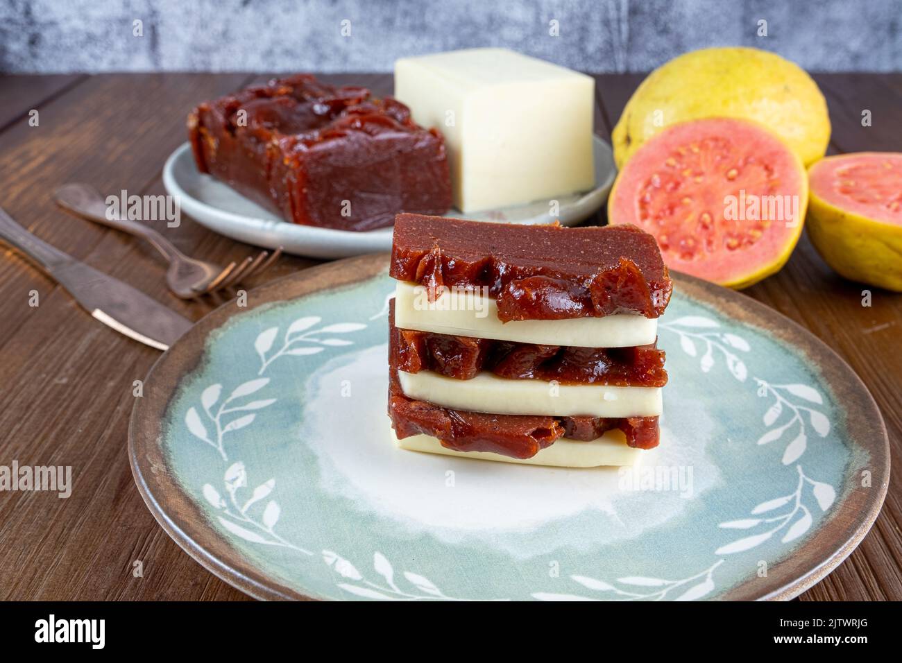 Stacked slices of guava sweet and curd cheese. In the blurred ...