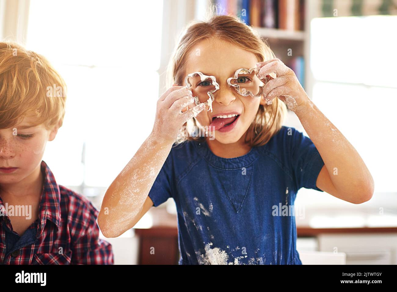 Live, laugh, bake. Portrait of a young girl having some fun while ...