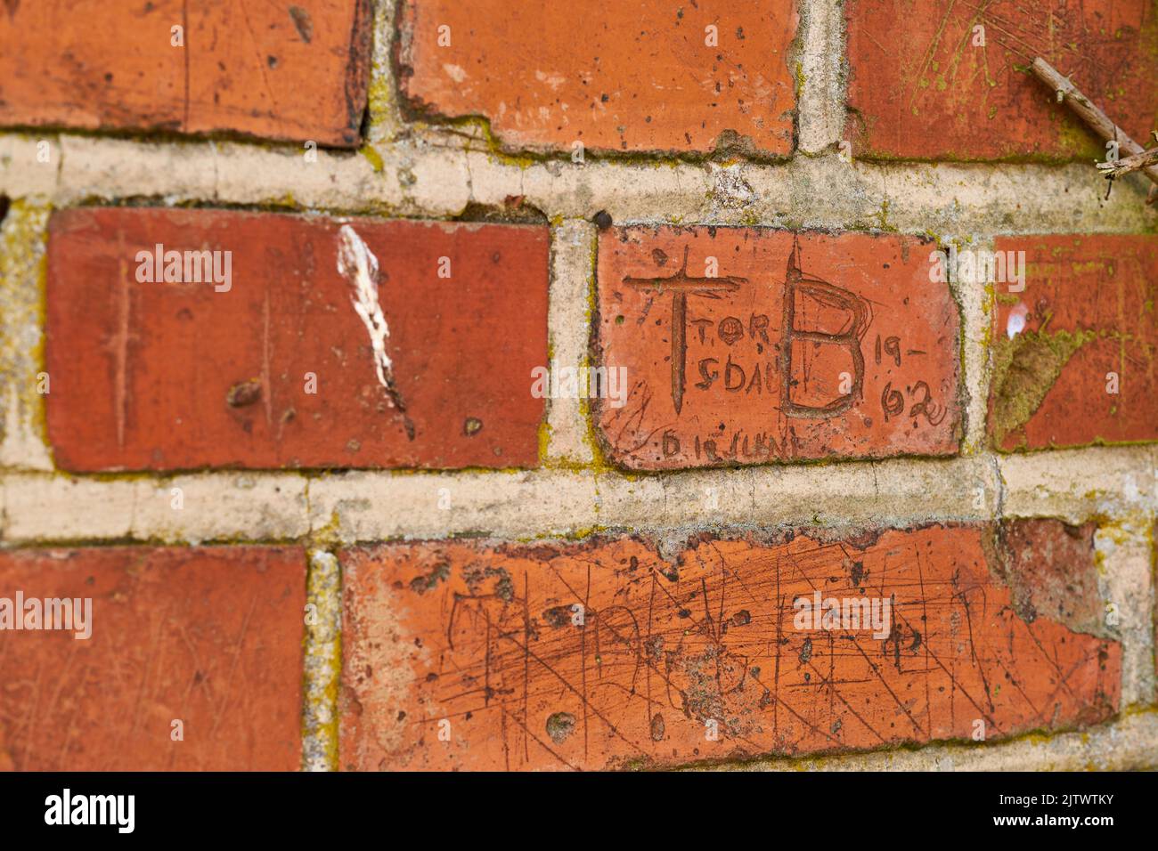 Signature wall. A photo of brick wall of an old school with a lot of ...