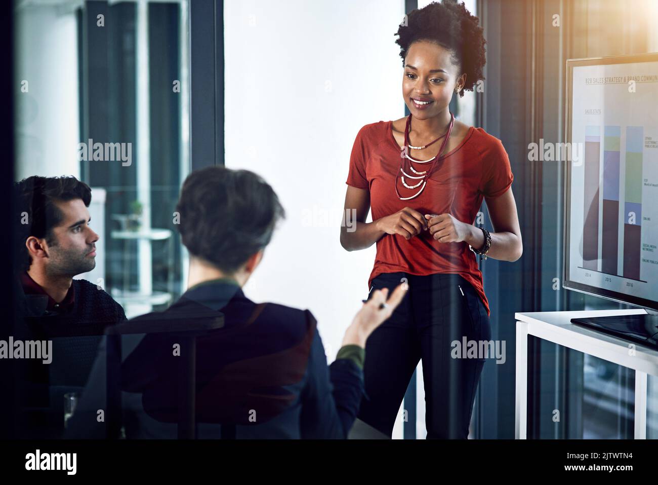 Shes happy to answer any questions. a young businesswoman giving a ...