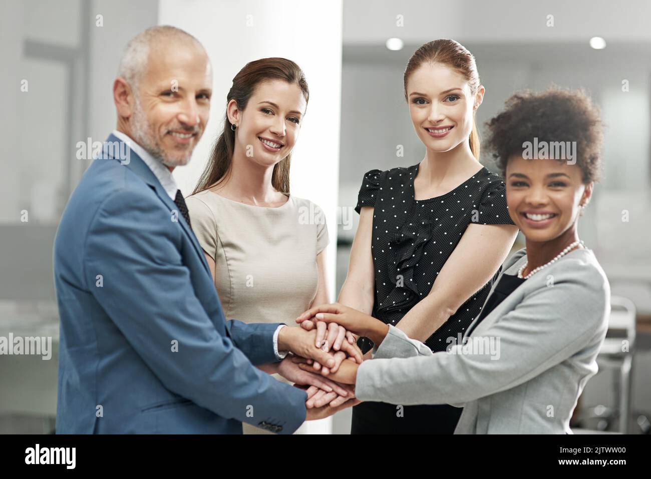 Team motivation. Portrait of a group of businesspeople joining their ...