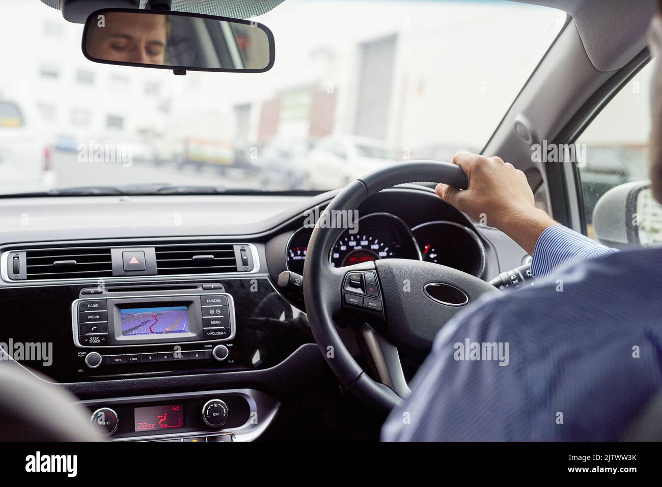 Following directions to the next destination. a businessman driving a ...