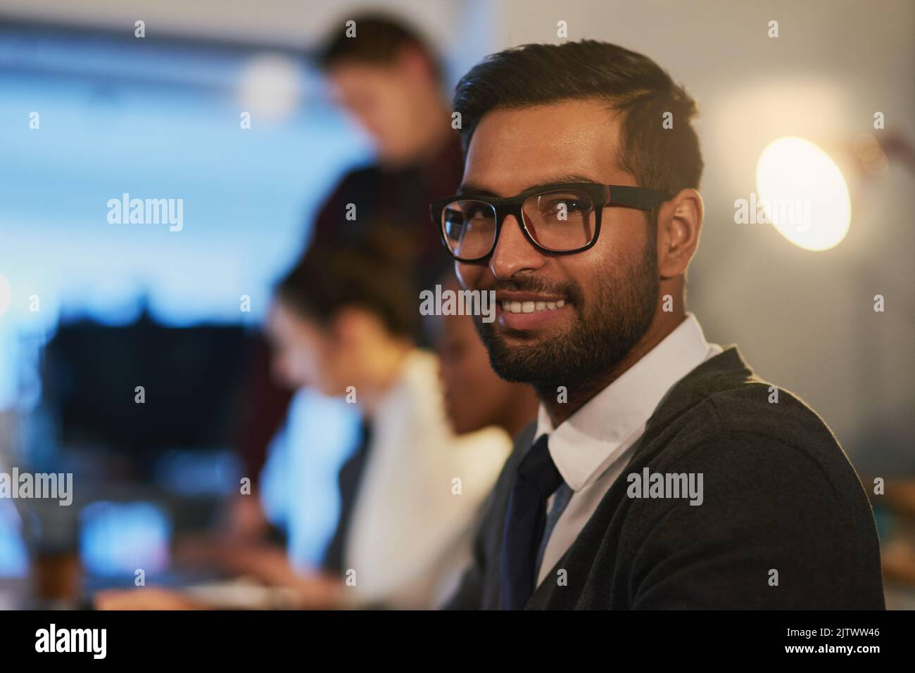 I Dont Mind The Late Nights Cropped Portrait Of A Young Businessman And His Colleagues Working