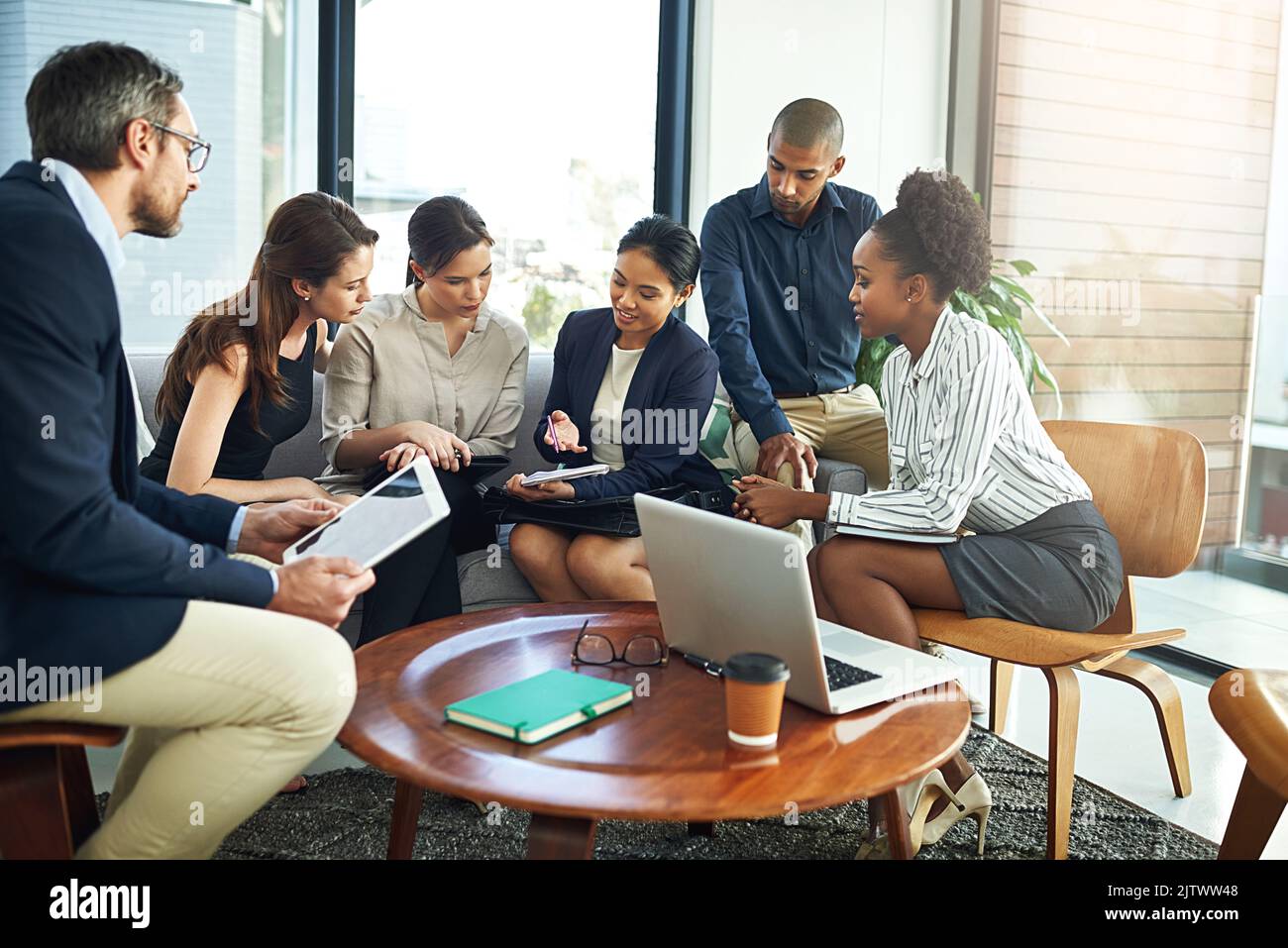 Strategy session in progress. a group of businesspeople discussing work ...
