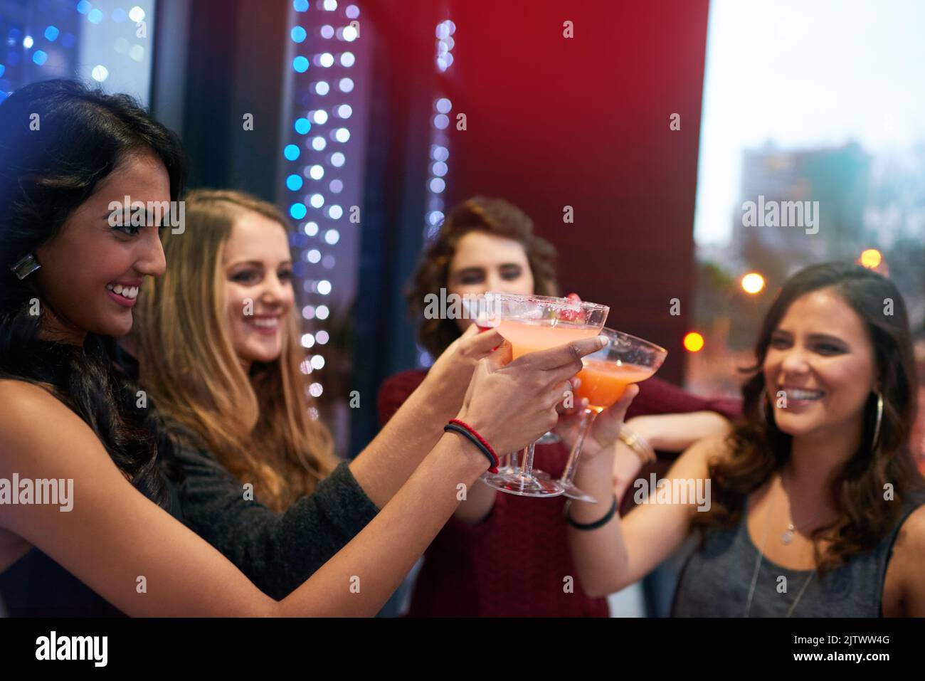 The fun starts now. a group of young women celebrating with cocktails ...