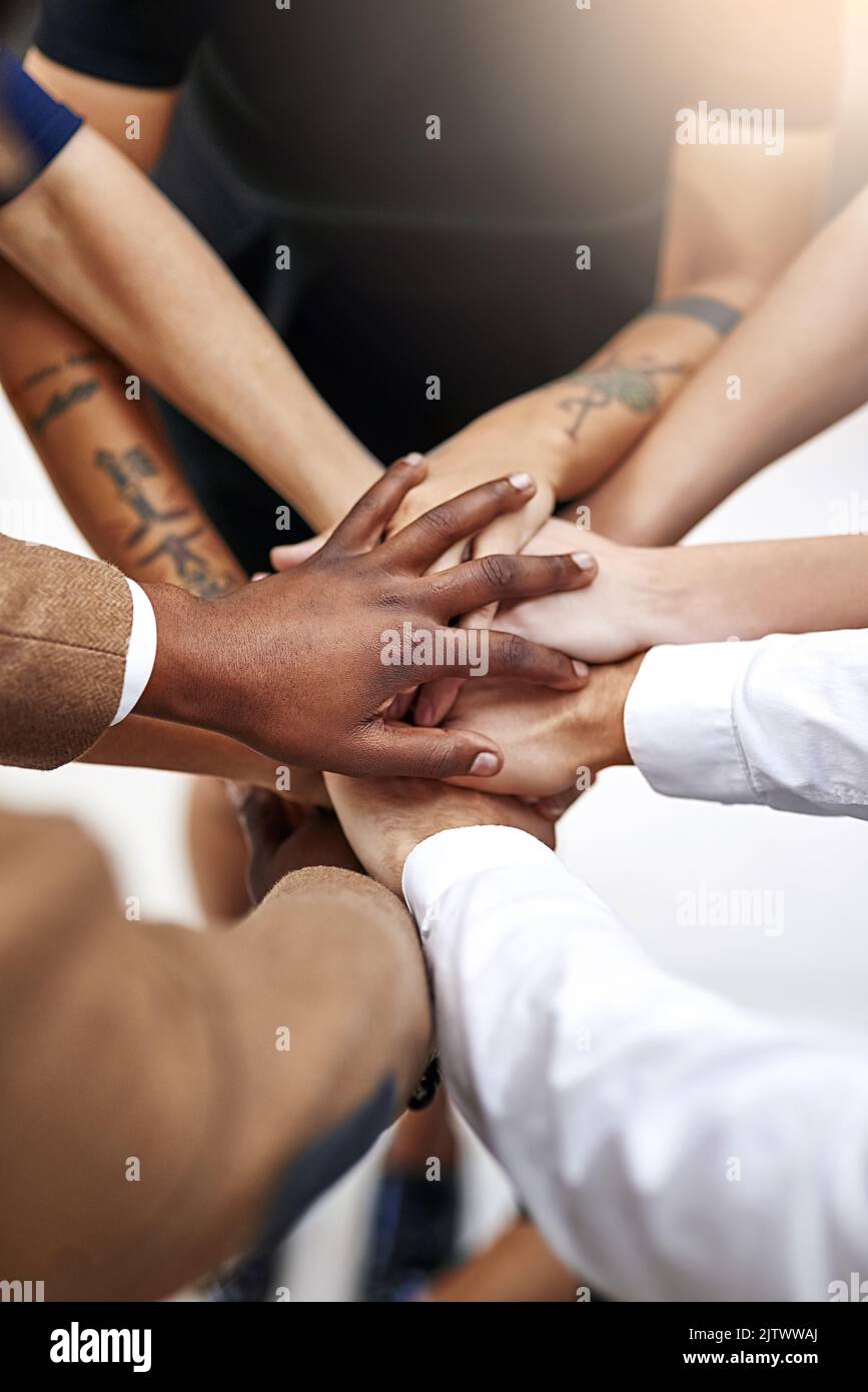 Teamwork and success go hand in hand. Closeup shot of a group of people joining their hands ...